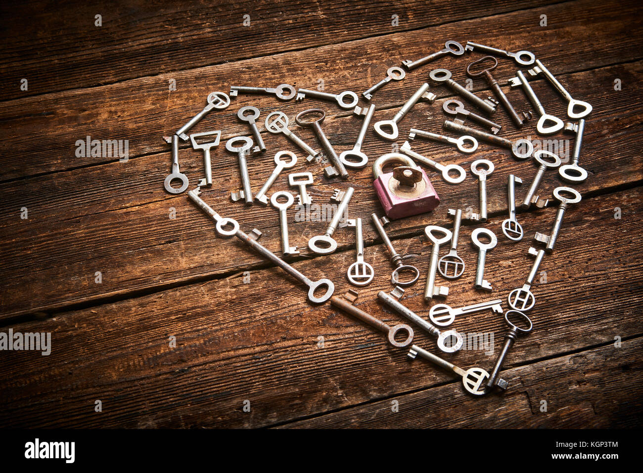 Old keys in a heart shape, on a wood surface, vintage look Stock Photo ...