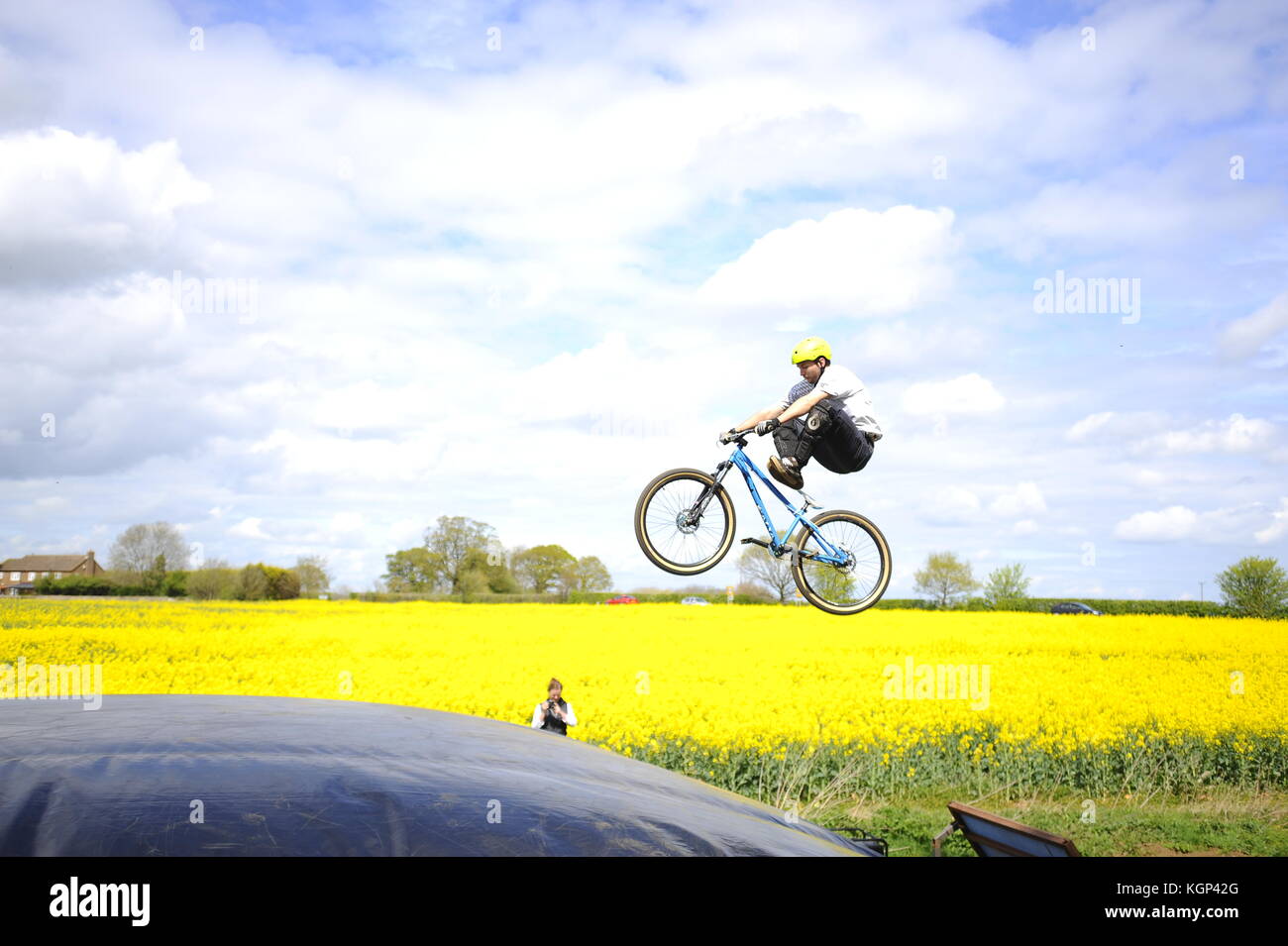 Mountain biking at Chicksands, Bedfordshire. Riders jumping off a large ...