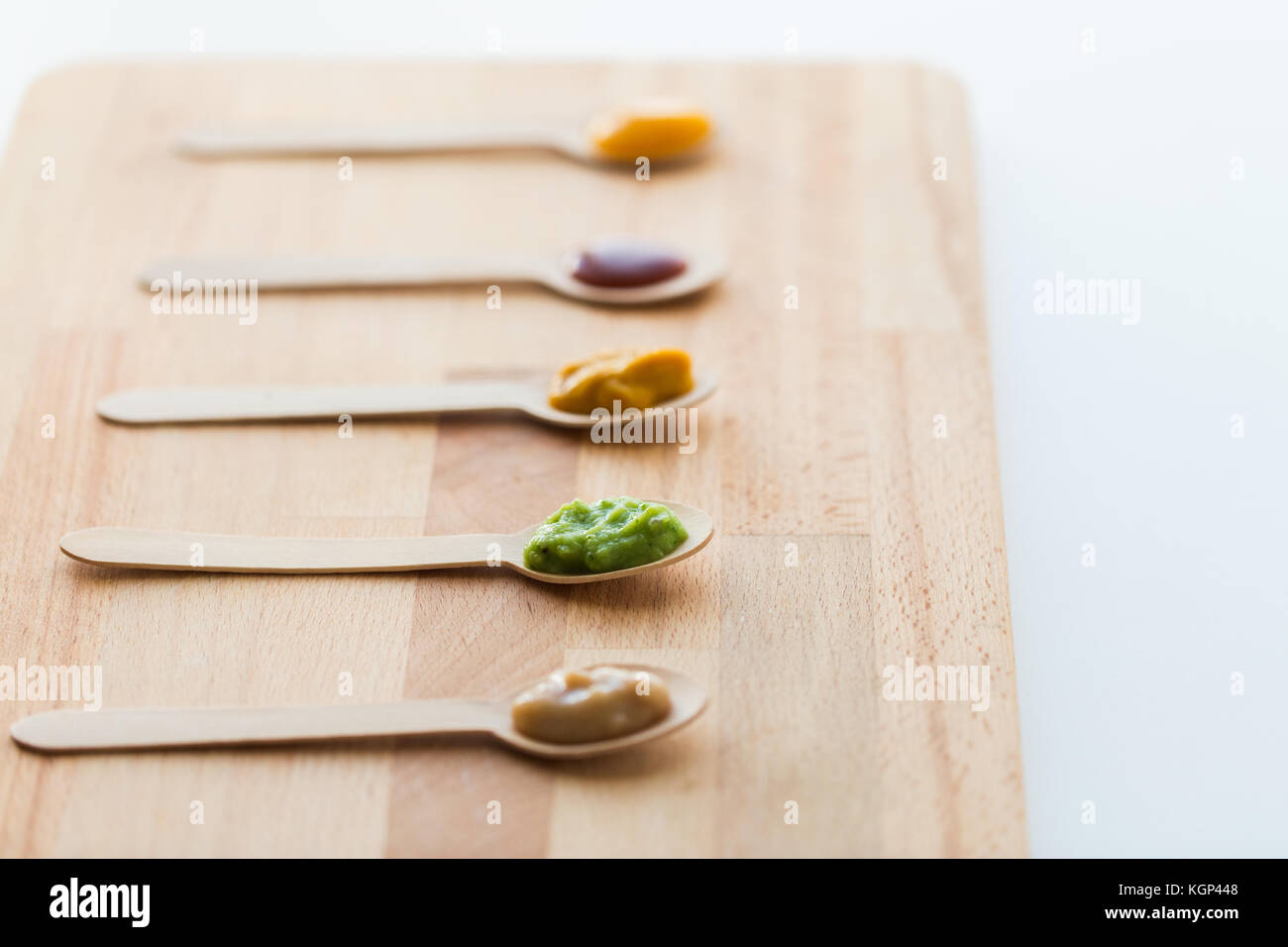 vegetable or fruit puree or baby food in spoons Stock Photo - Alamy