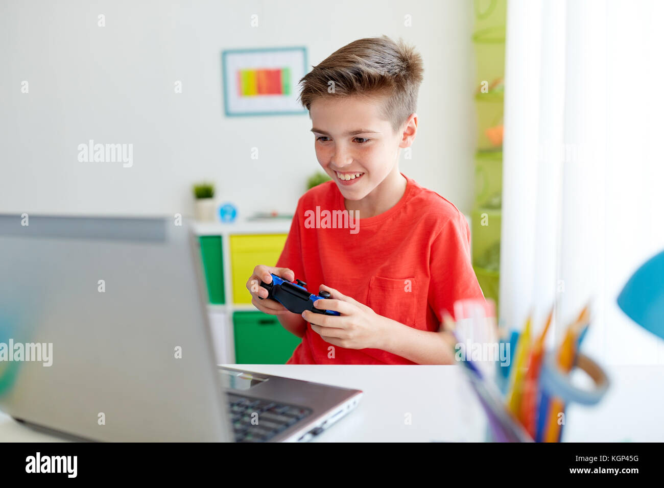 Boy playing game on laptop hi-res stock photography and images - Alamy