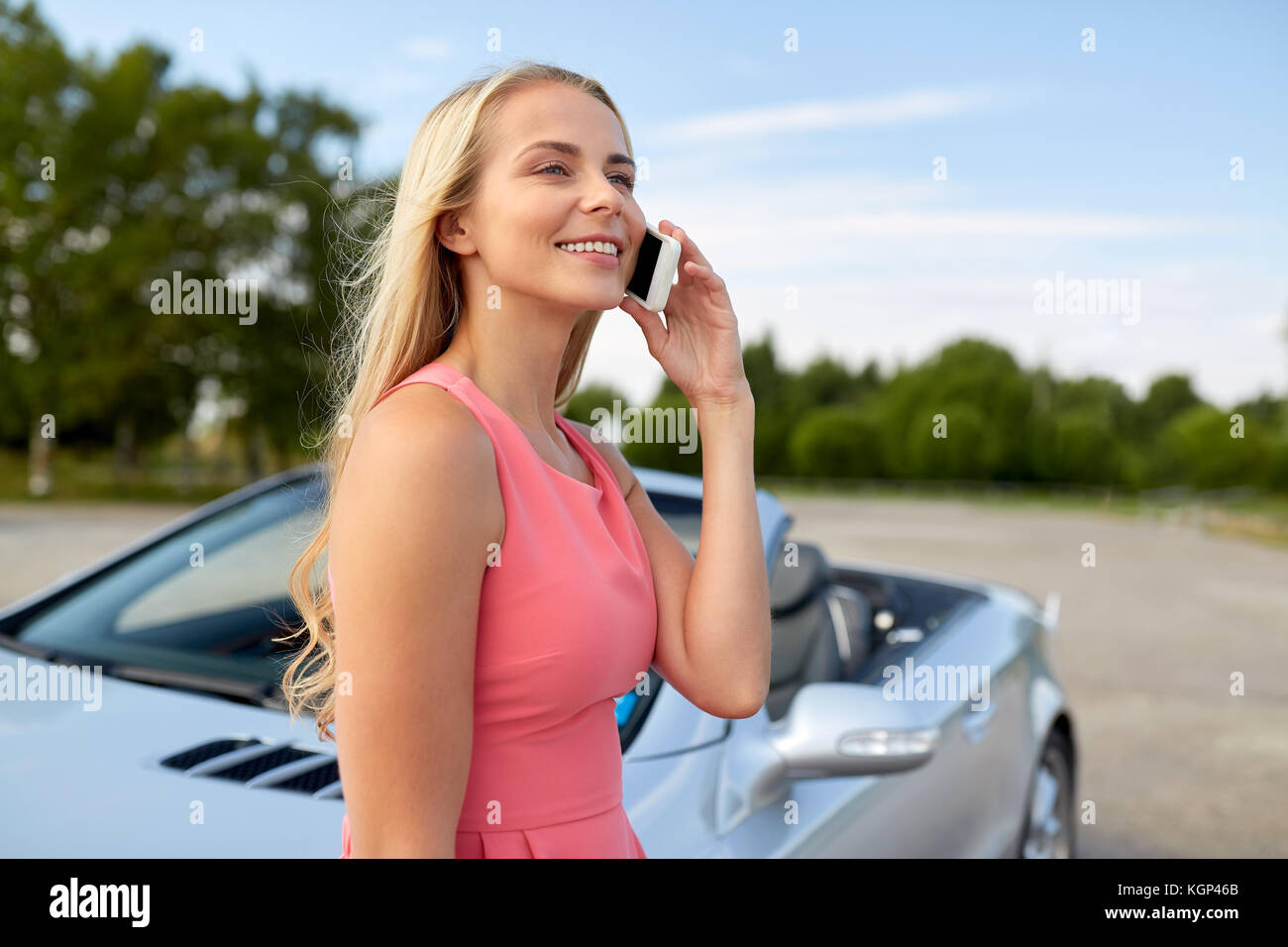 woman calling on smartphone at convertible car Stock Photo - Alamy