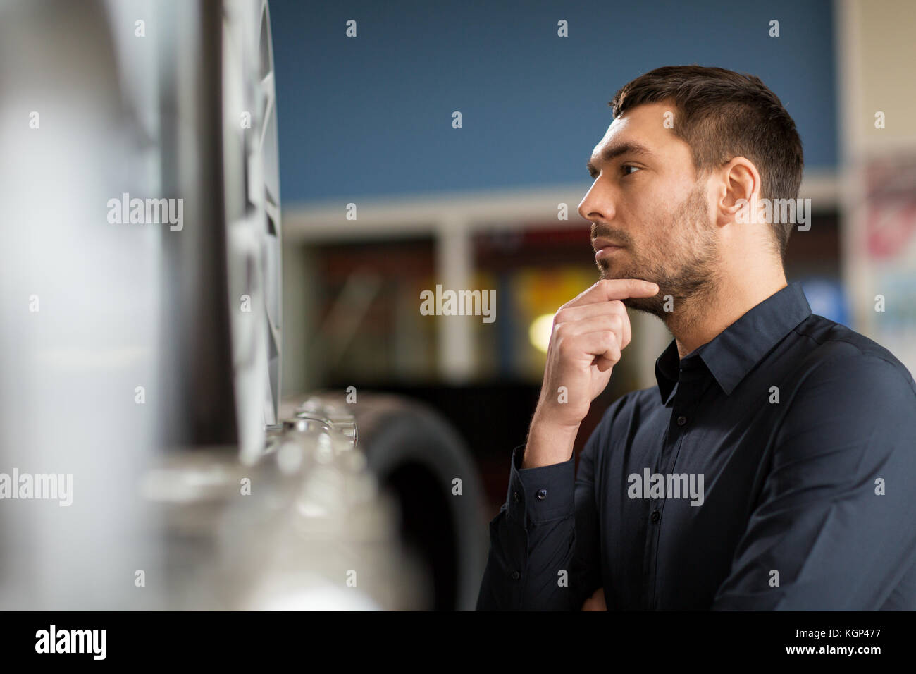 male customer choosing wheel rims at car service Stock Photo - Alamy