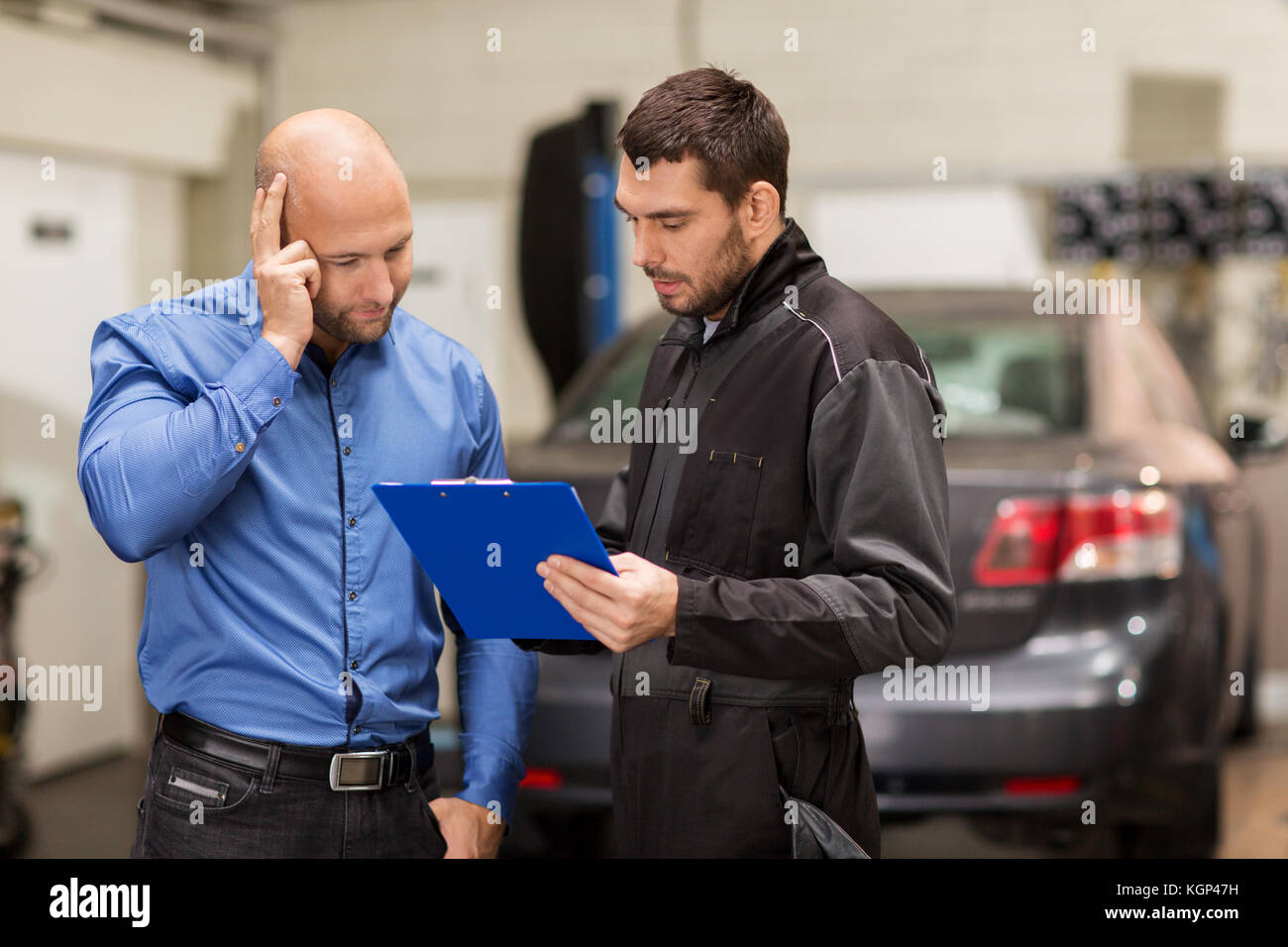 auto mechanic and customer at car shop Stock Photo - Alamy
