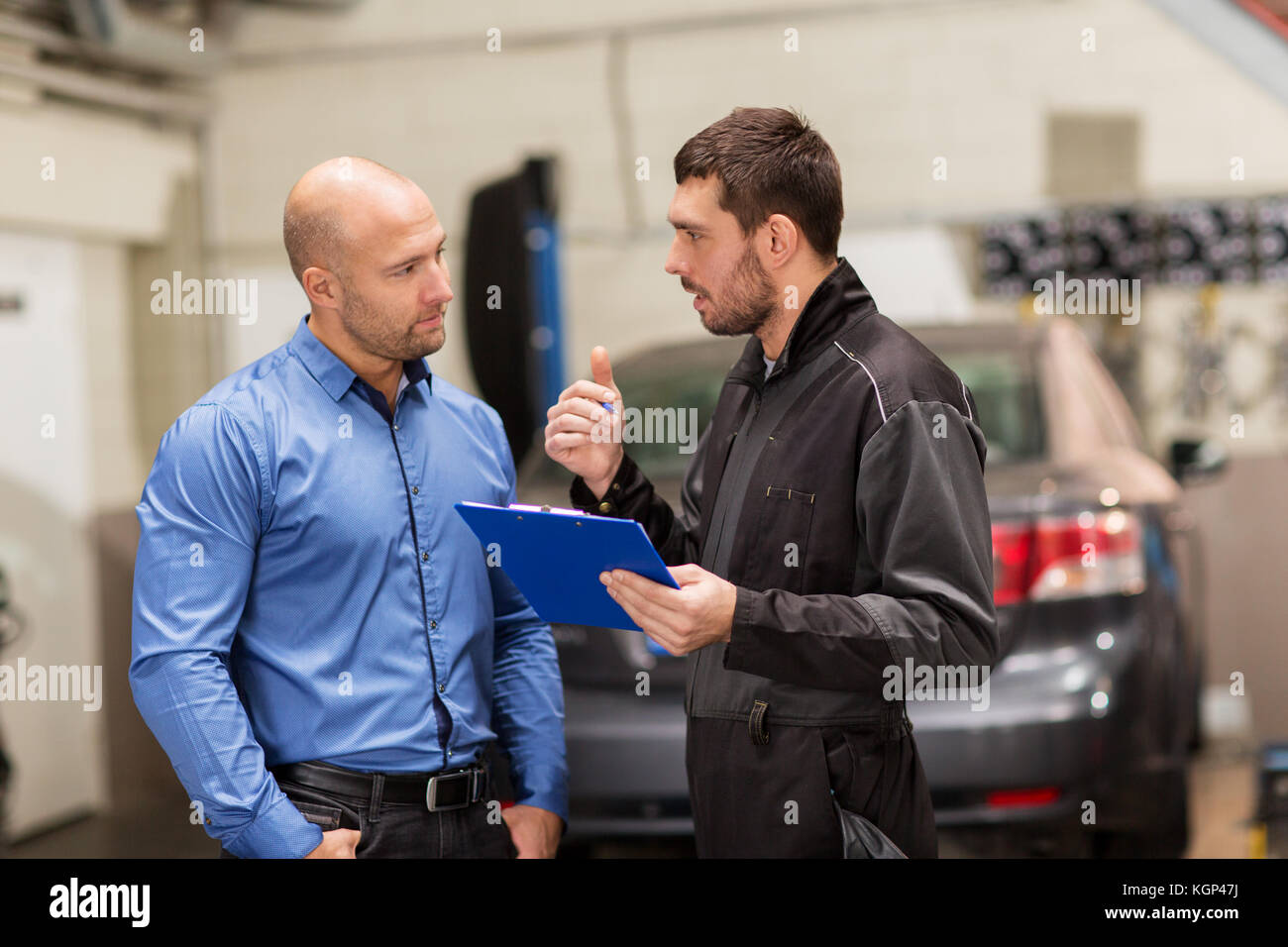 auto mechanic and customer at car shop Stock Photo - Alamy