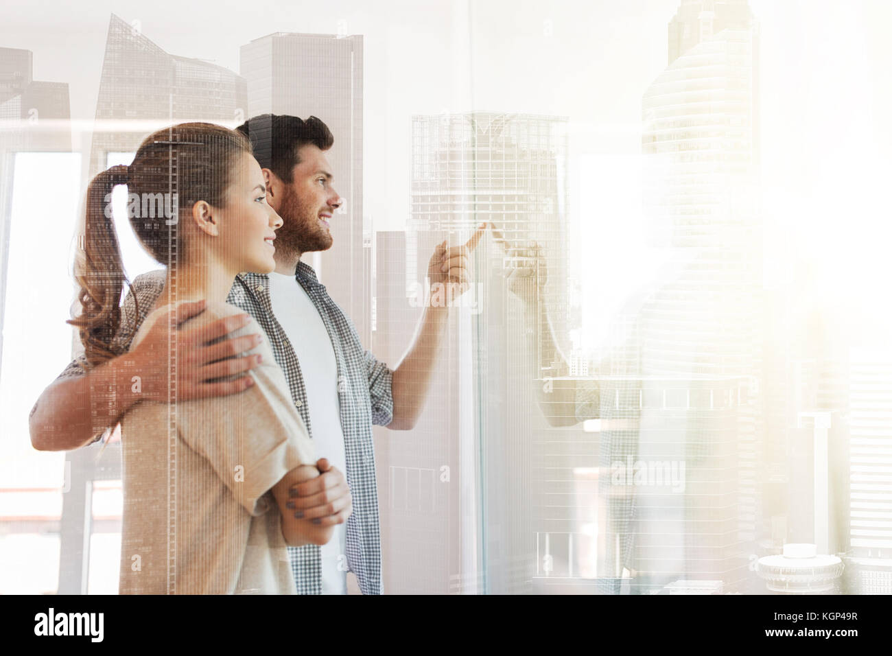 happy couple looking through window at new home Stock Photo - Alamy