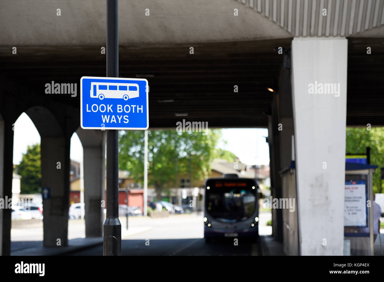 Warning sign to look both ways for buses in a shared space area ...