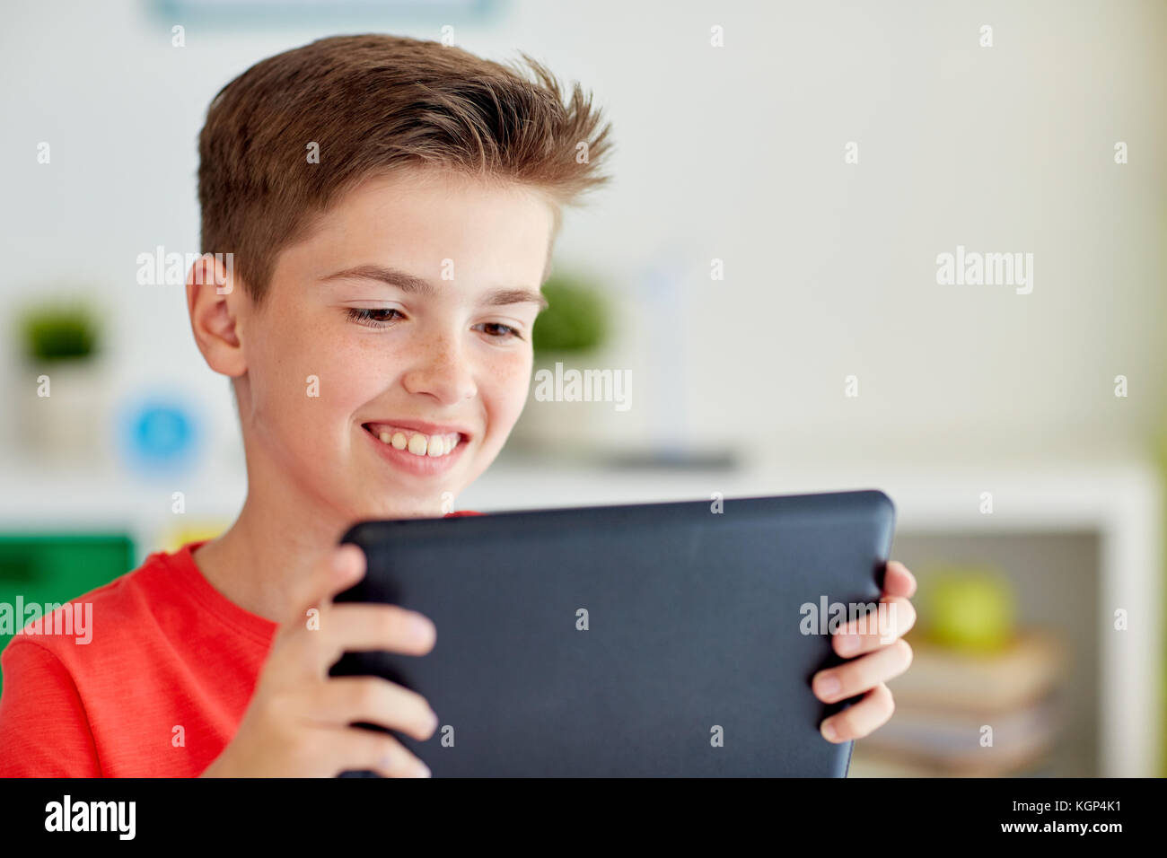 childhood, technology and people concept - close up of smiling boy with ...