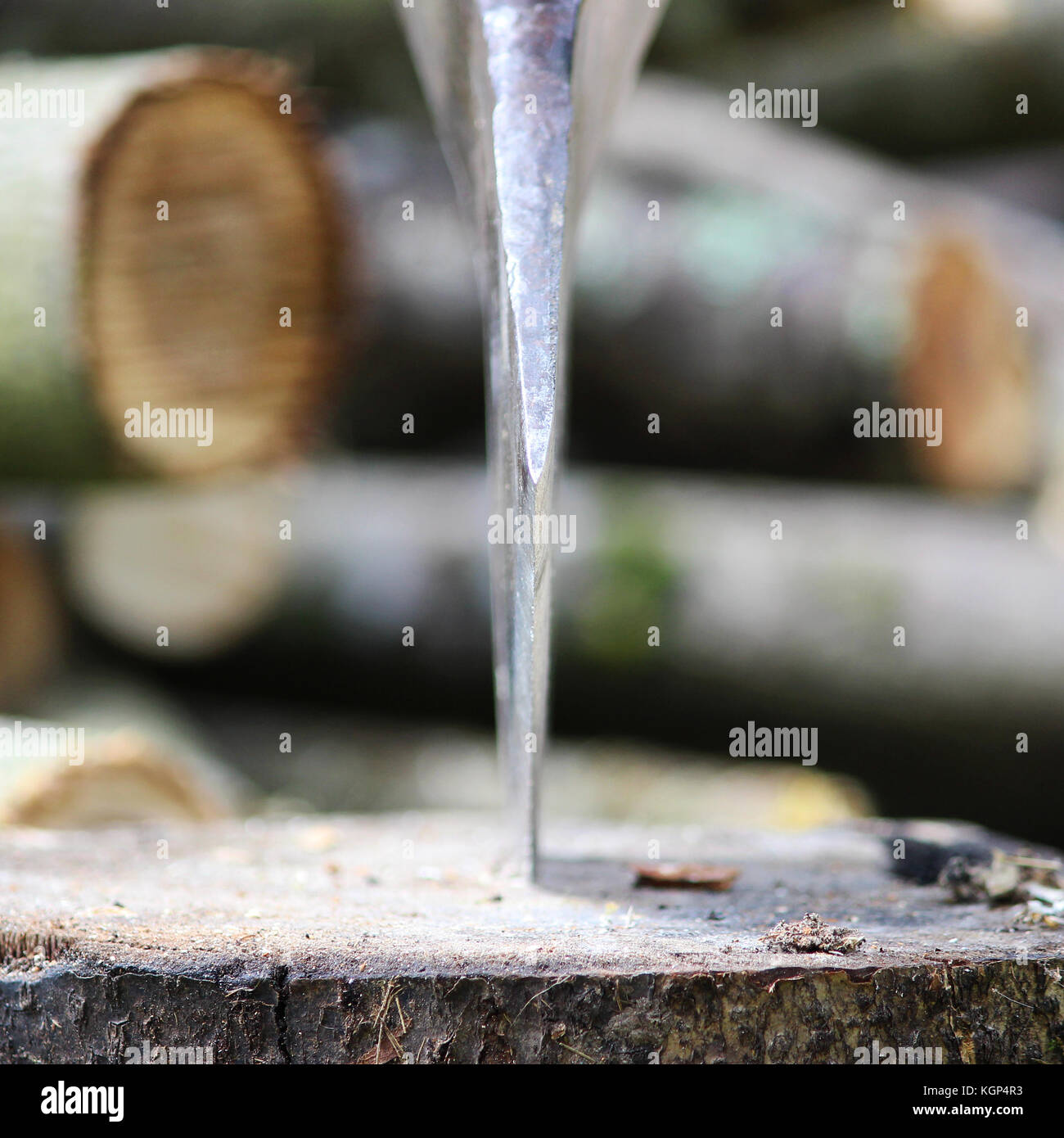 A sharp blade of an ax that sticks out in a wooden chock. rustic ...