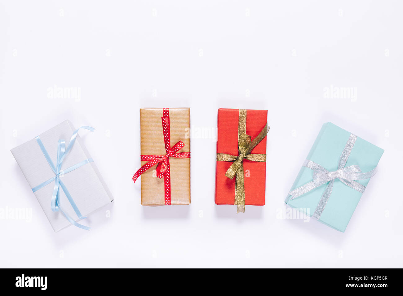 Red and blue gift boxes with ribbons on a white table top view Stock ...