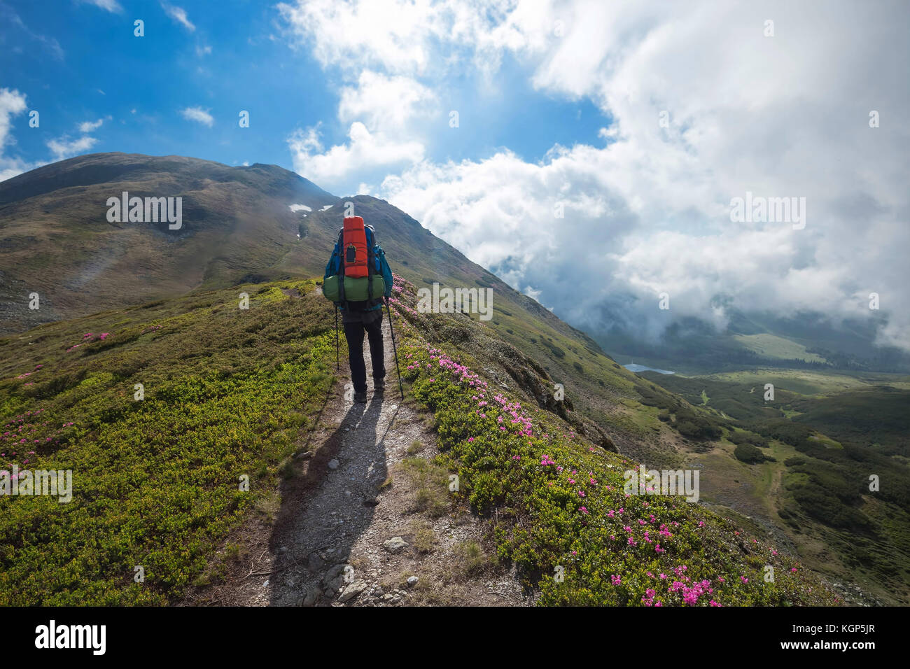 Hiker on mountain path in summer with backpack equipment and trekking ...