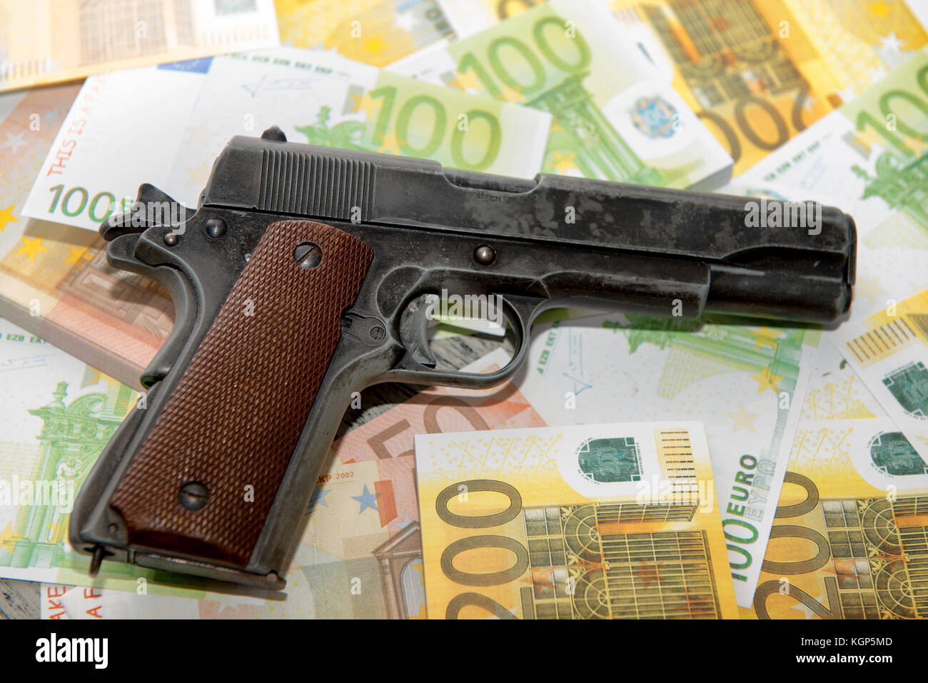 a close up image of pistol and euro money Stock Photo - Alamy