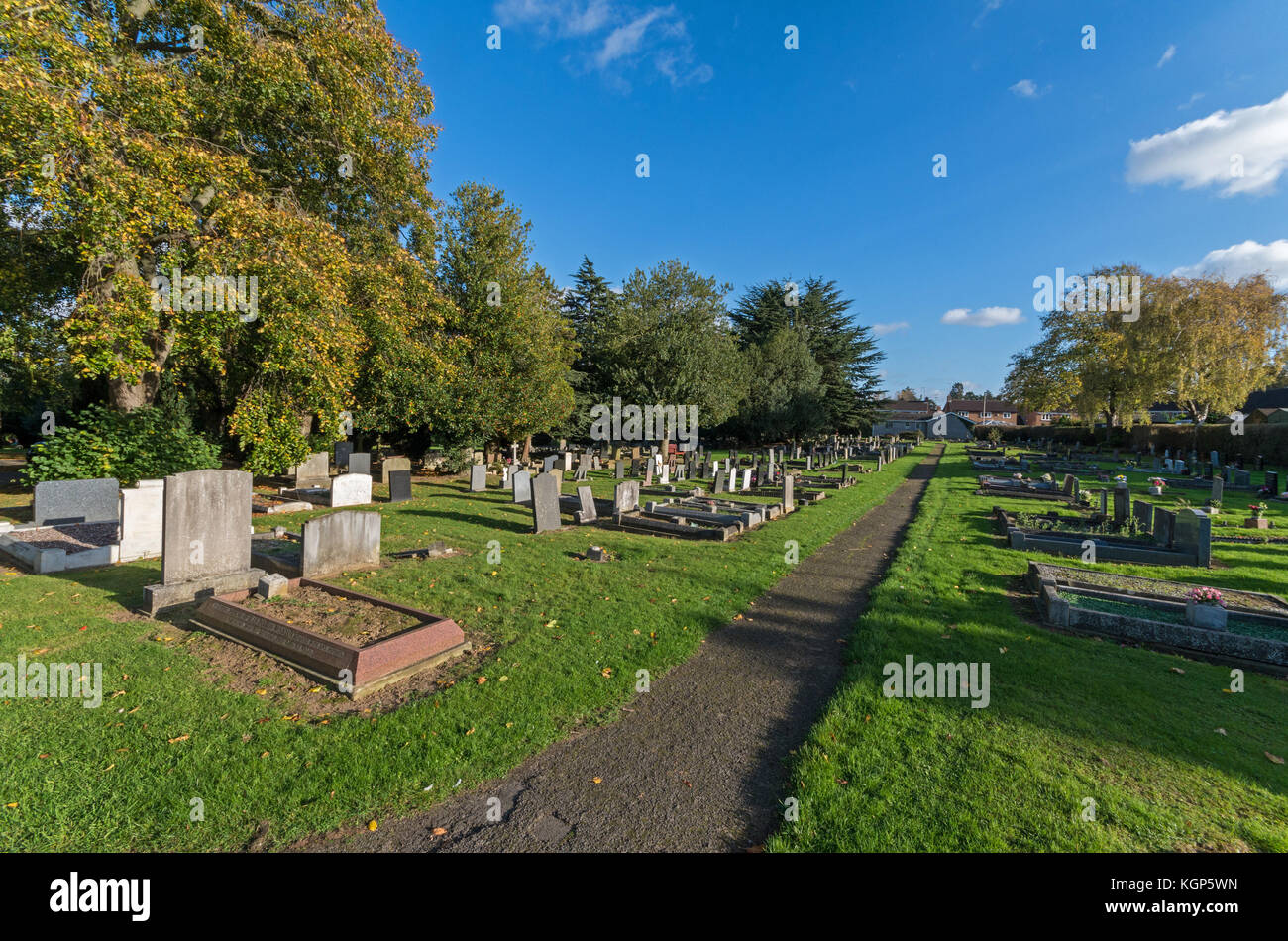 A path flanked by gravestones running through Dallington Cemetery ...