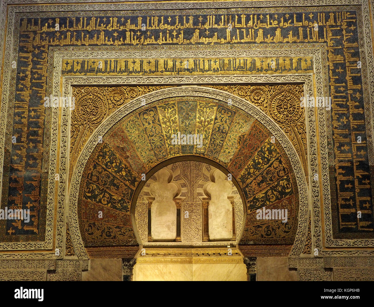 elaborate gold mosaics surrounding arched entrance to the Mihrab at the ...