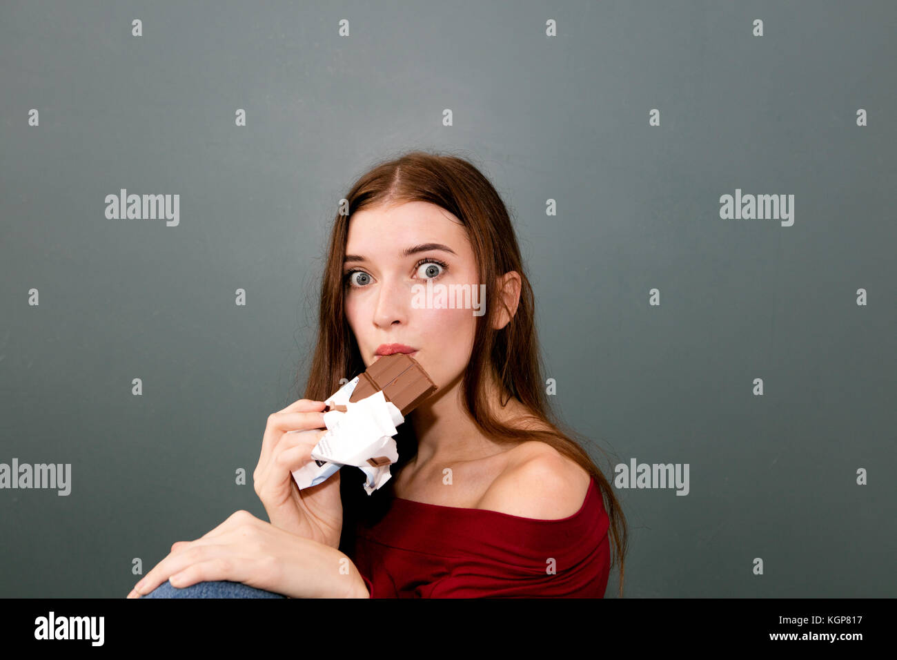 Close-up girl eating chocolate Bar Stock Photo - Alamy
