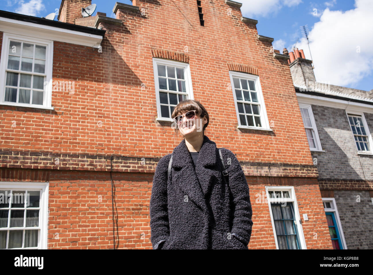 Hipster woman wearing sunglasses and wool black jacket with Victorian ...