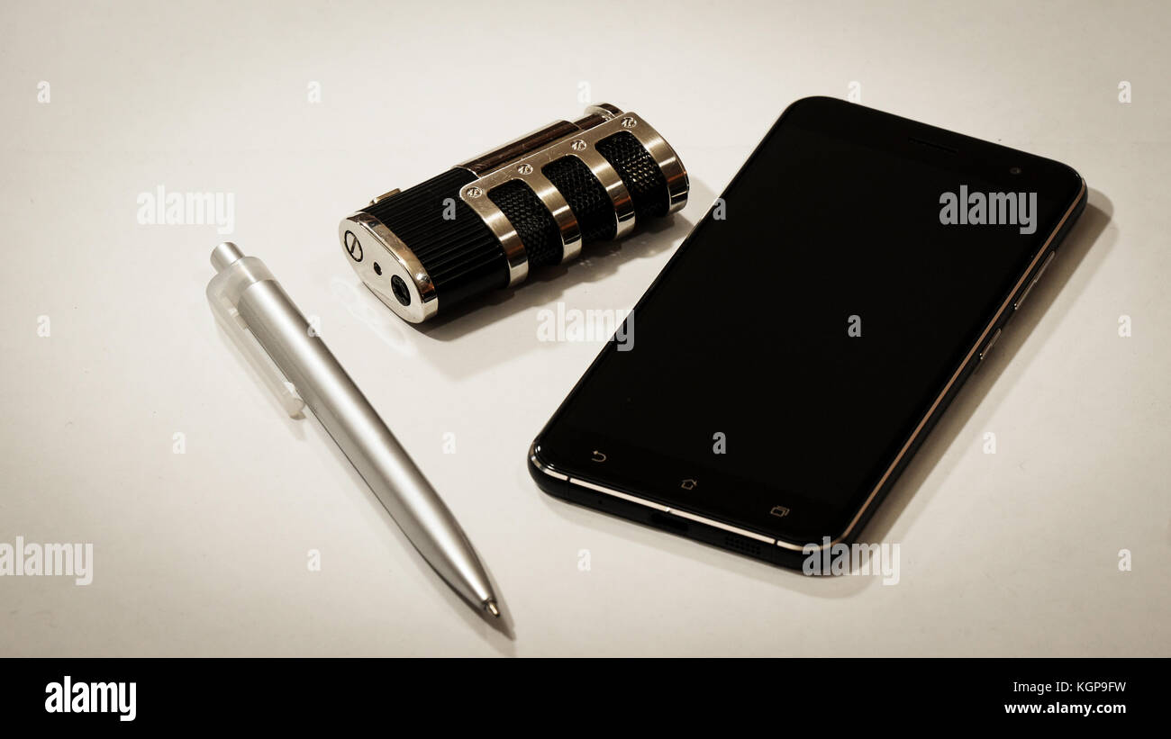 cigar lighter smart phone and pen combination Stock Photo - Alamy