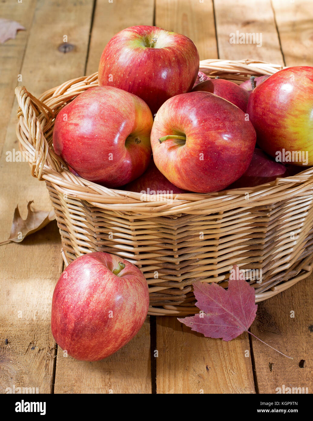 Basket of red apples on a wood surface Stock Photo - Alamy