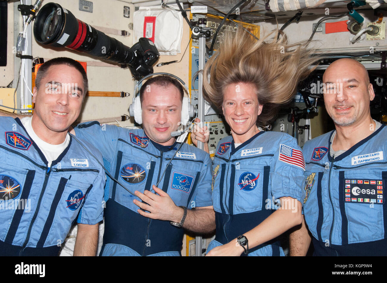 Expedition 36 flight engineers pose for a portrait in the Zvezda ...