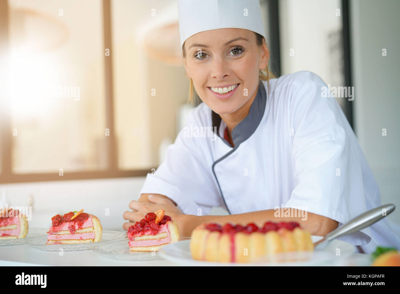 Smiling pastry chef standing in restaurant kitchen Stock Photo - Alamy