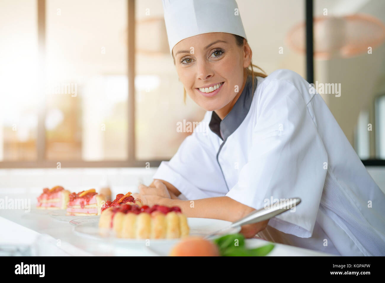 Smiling pastry chef standing hi-res stock photography and images - Alamy