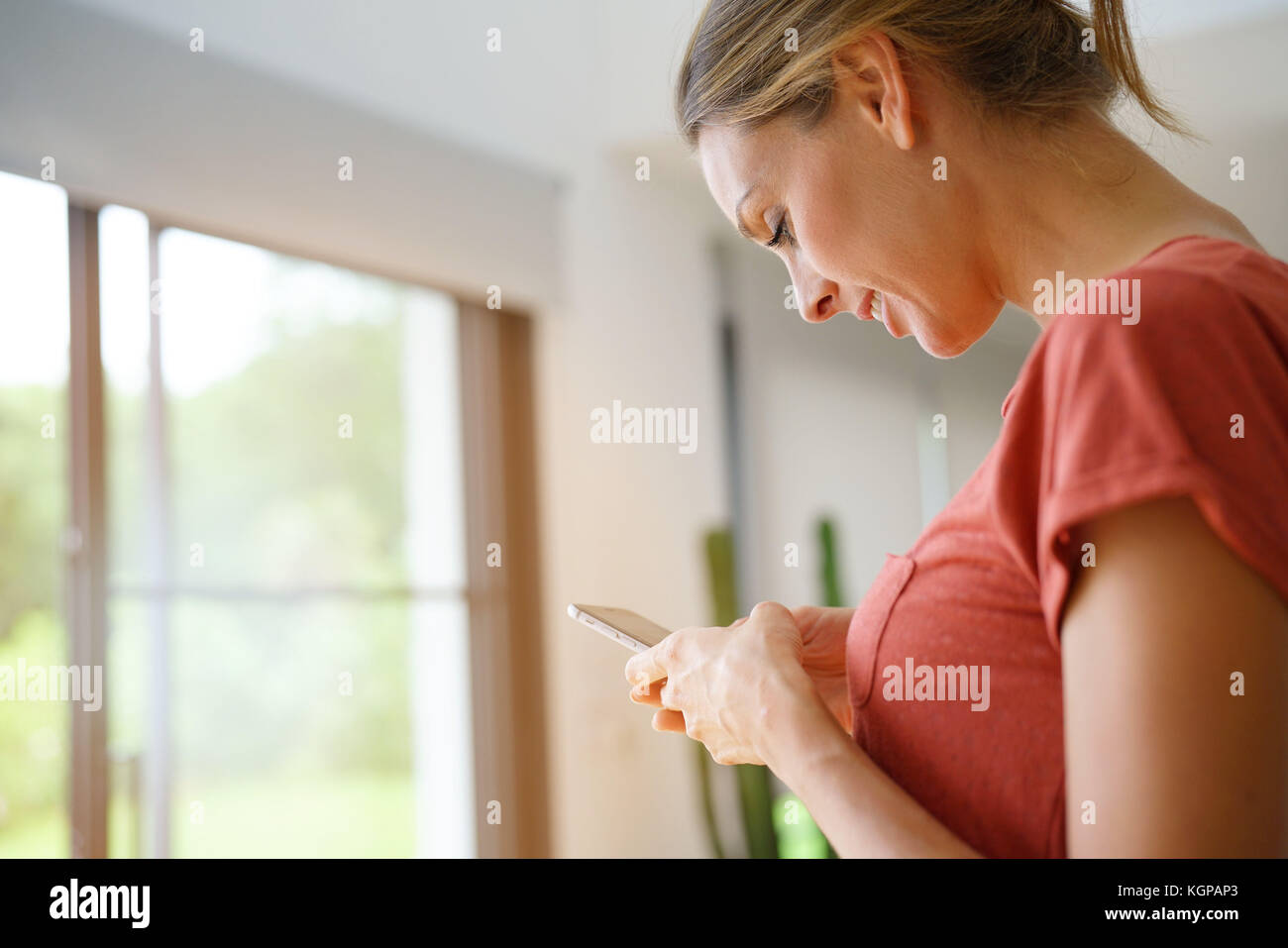 Woman sending text message with smartphone Stock Photo - Alamy