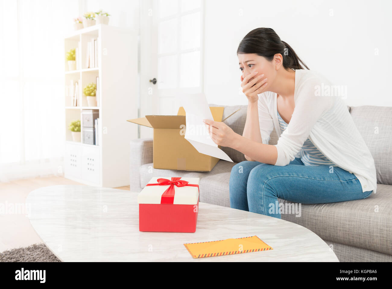 sadness unhappy woman sitting on sofa reading letter content crying ...