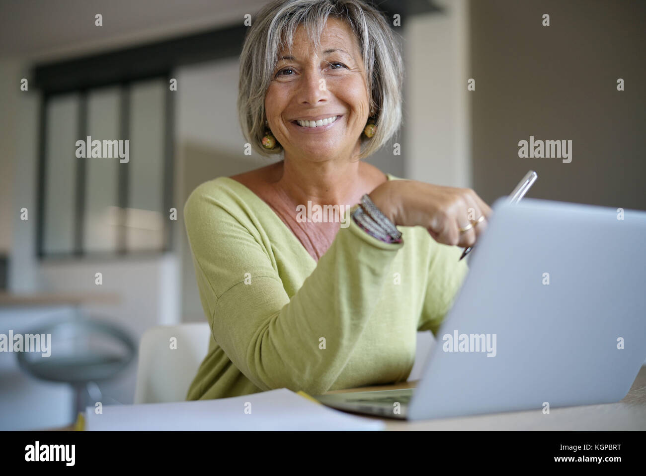 Senior woman at home using laptop computer Stock Photo - Alamy