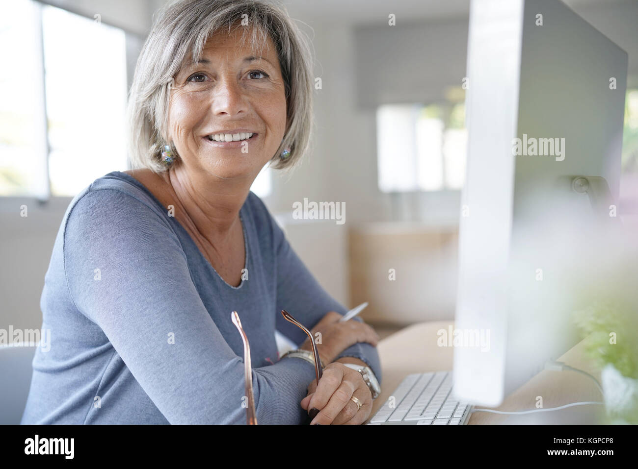 Portrait of mature woman working in office Stock Photo - Alamy