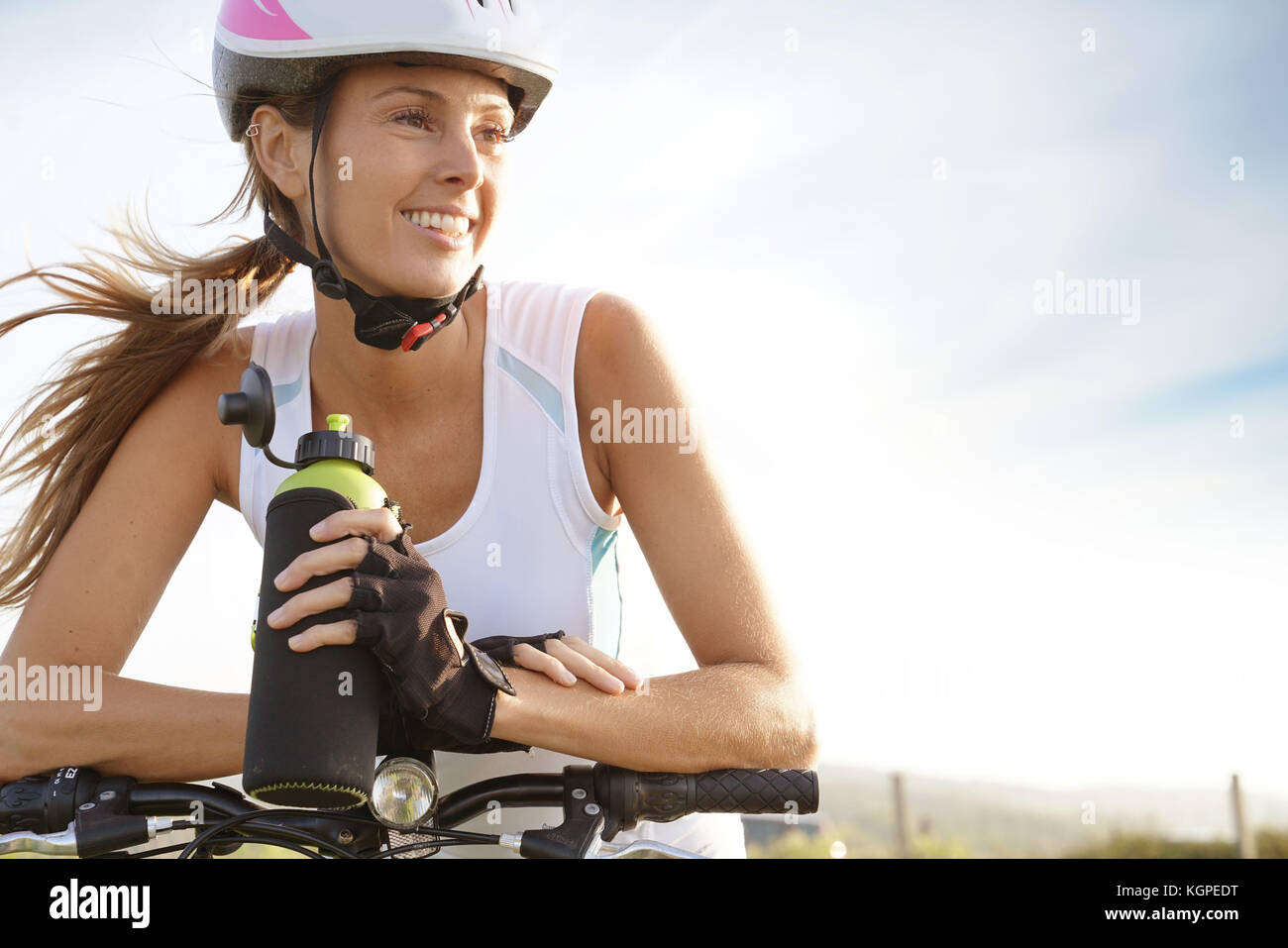 Portrait of woman on biking journey drinking water from bottle Stock ...