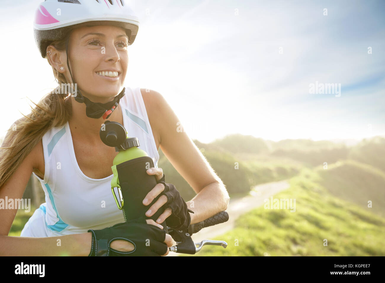 Girl riding bike drinking water hi-res stock photography and images - Alamy