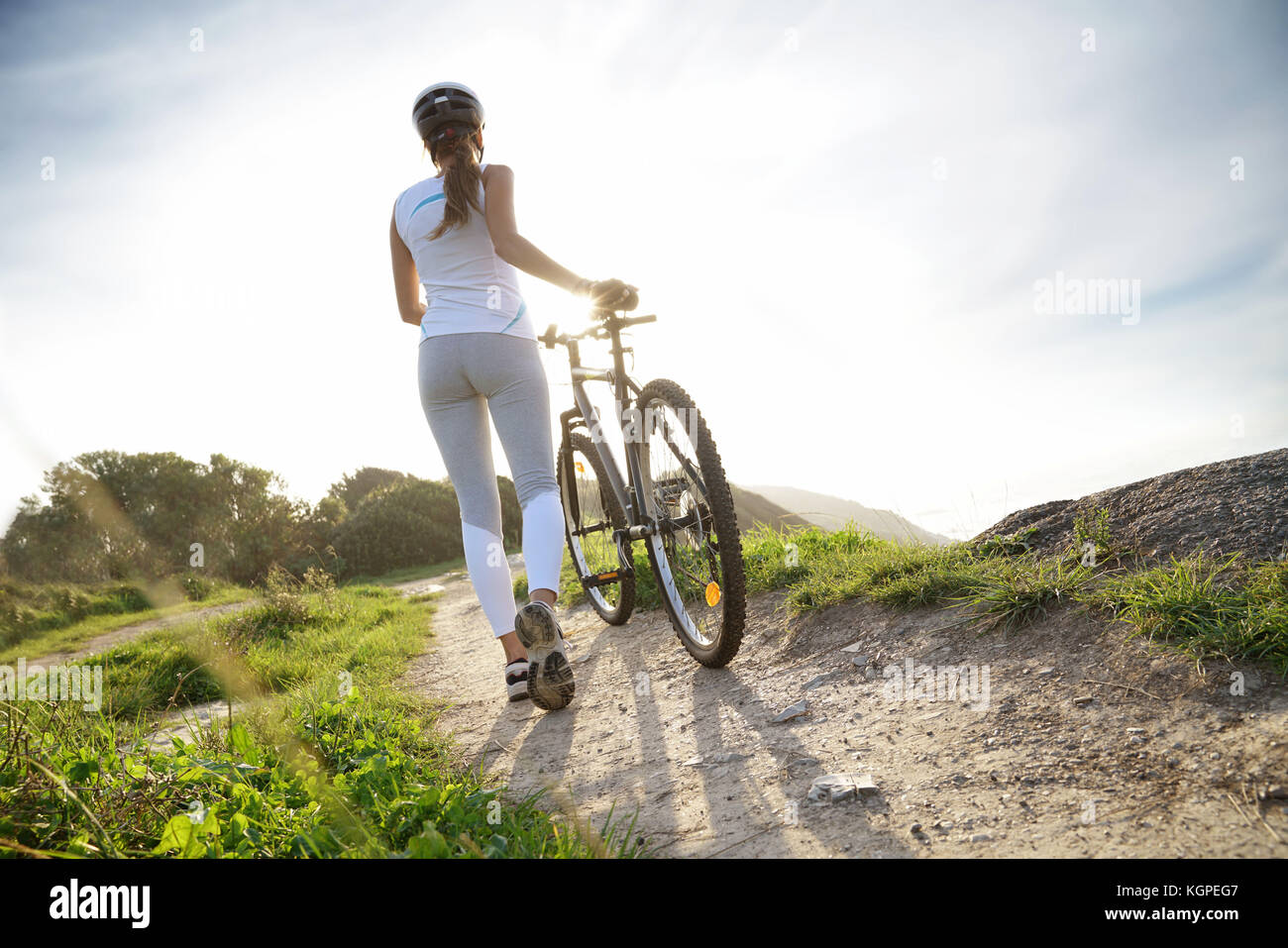 Girl Pushing Bike High Resolution Stock Photography and Images - Alamy