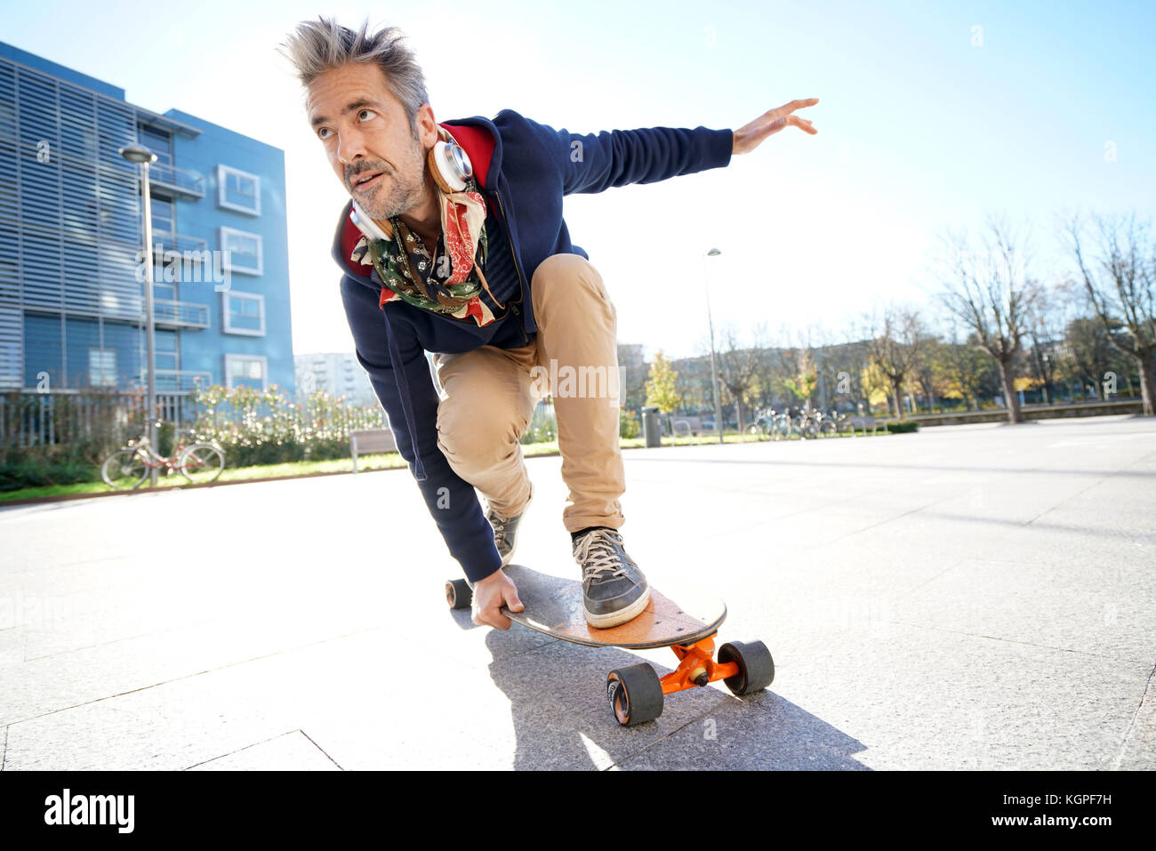 Mature man skateboarding in the street Stock Photo - Alamy