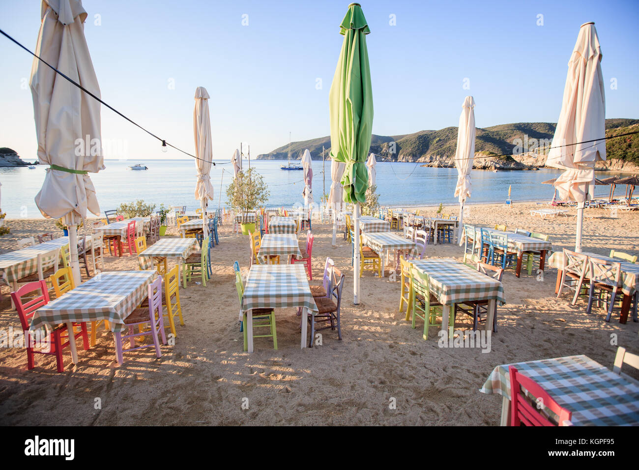 Greek taverna tables on the beach , traditional restaurant in the ...