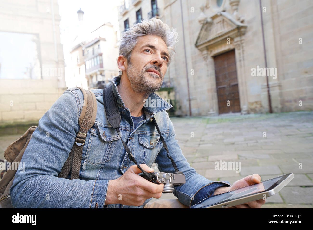 Reporter in historical town connected on digital tablet Stock Photo - Alamy
