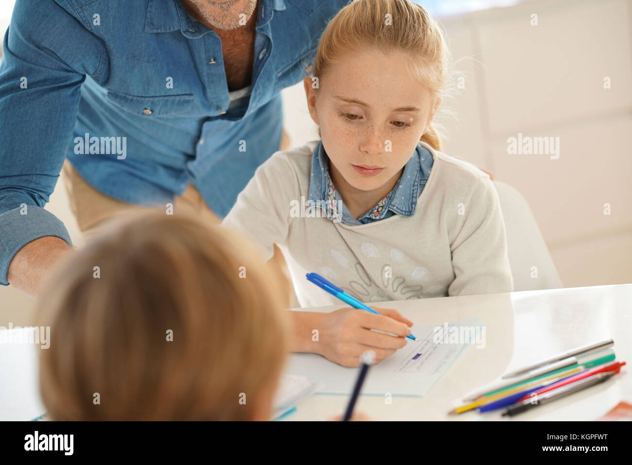 Portrait of school girl taking notes in class Stock Photo - Alamy