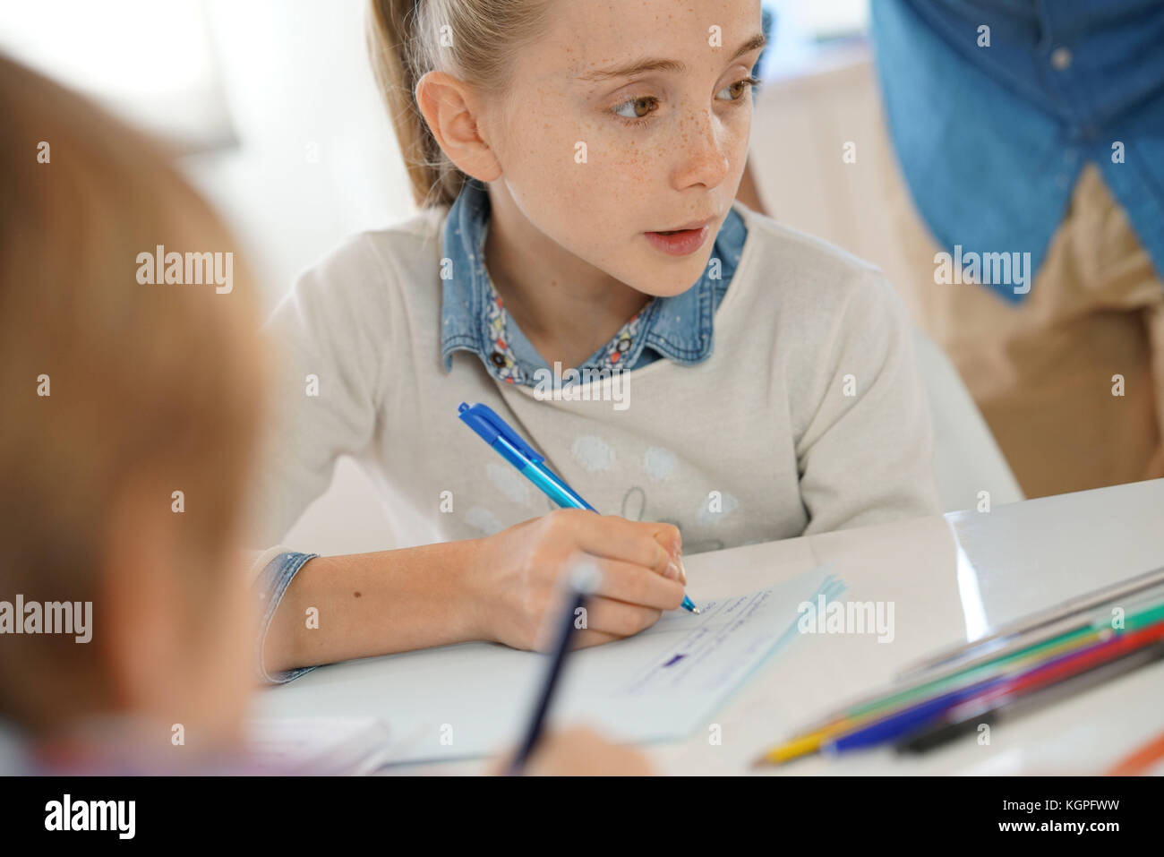 Portrait of school girl taking notes in class Stock Photo - Alamy