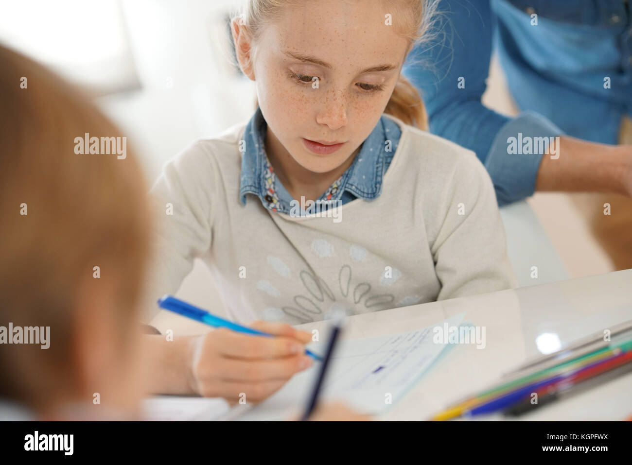 Portrait of school girl taking notes in class Stock Photo - Alamy
