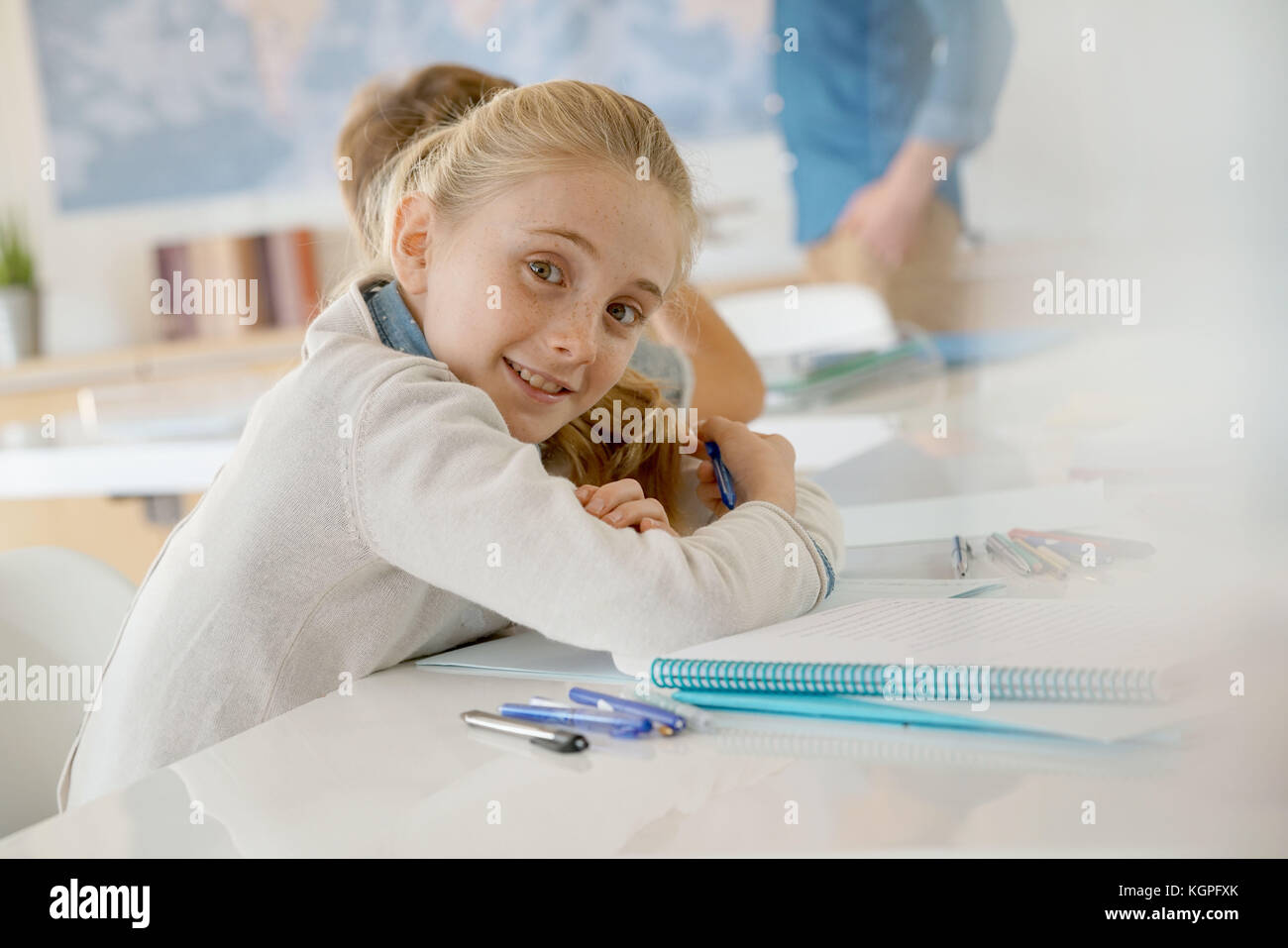 Portrait of school girl taking notes in class Stock Photo - Alamy