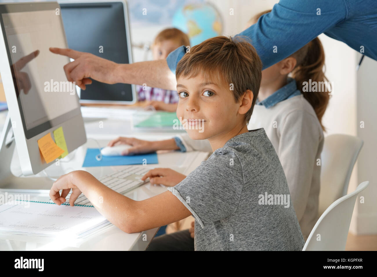 Portrait of school boy in computer lab Stock Photo - Alamy