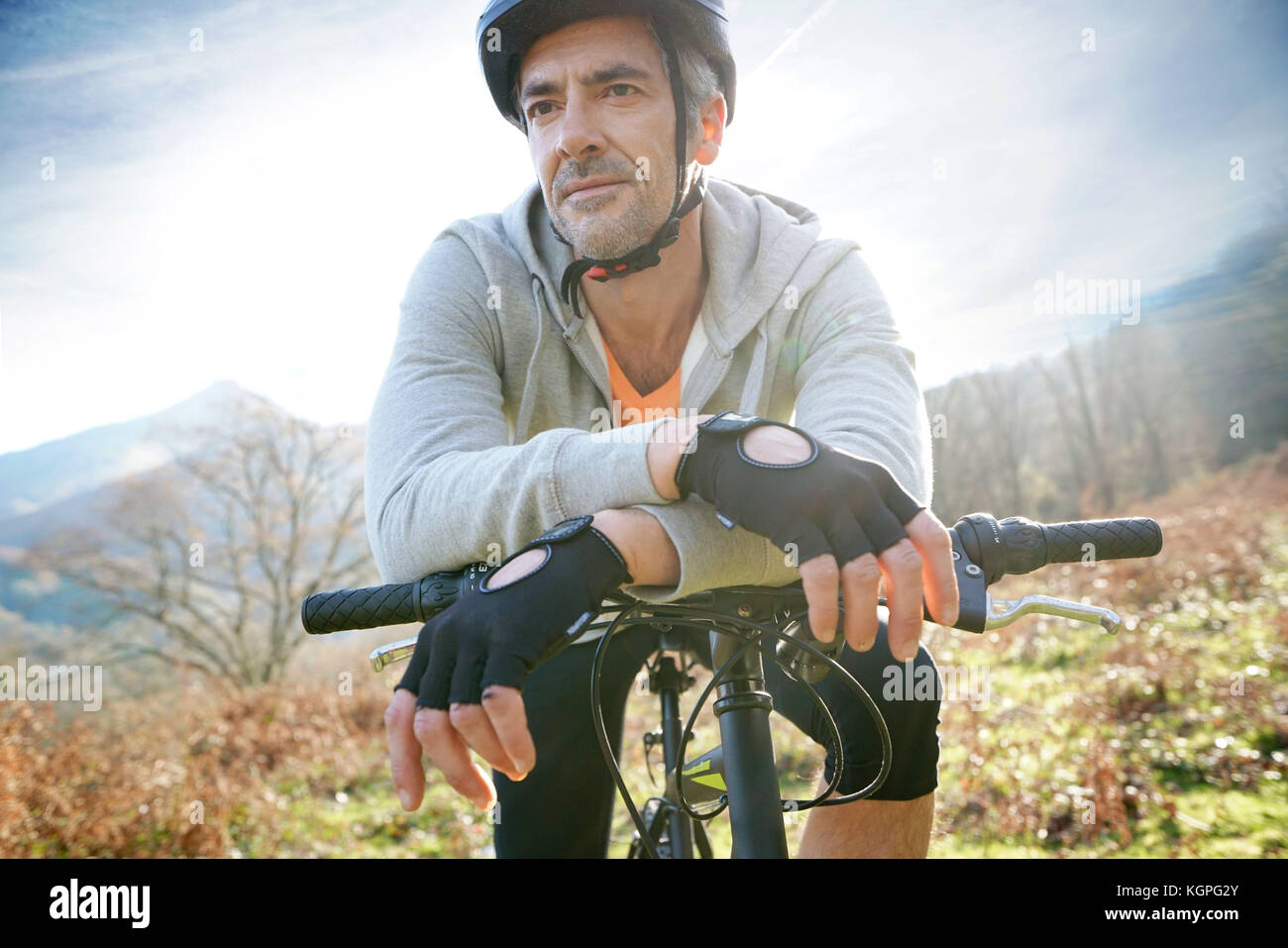 Mature man riding bike in the mountain Stock Photo - Alamy