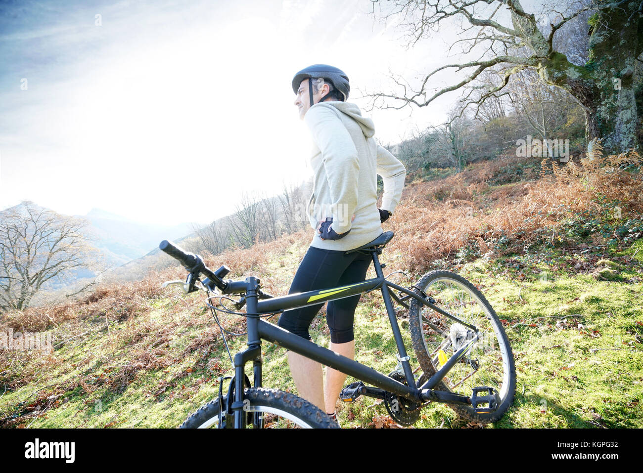 Biker relaxing on bike, admiring scenery Stock Photo - Alamy