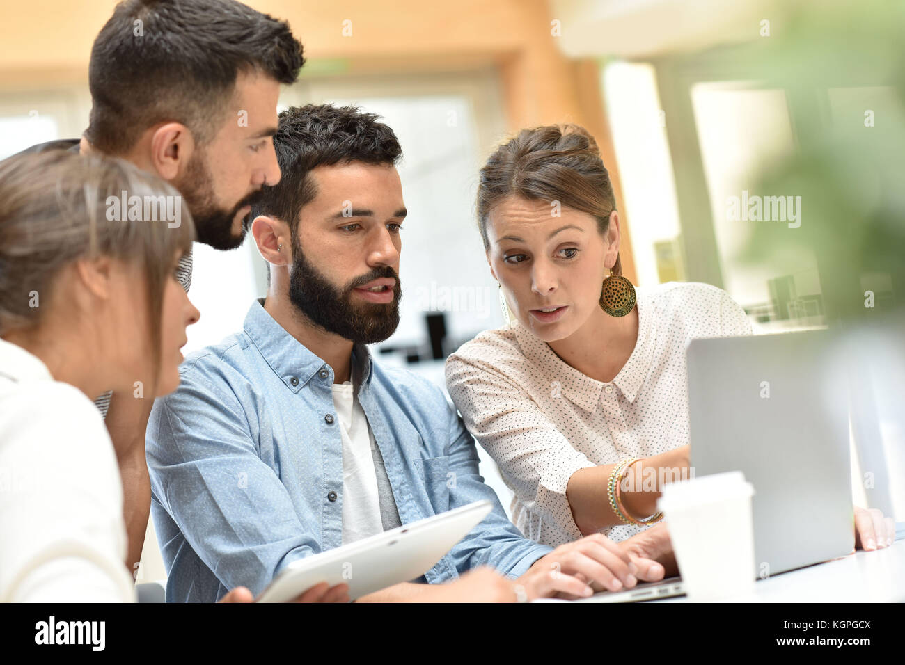 Design team meeting and working on laptop Stock Photo - Alamy