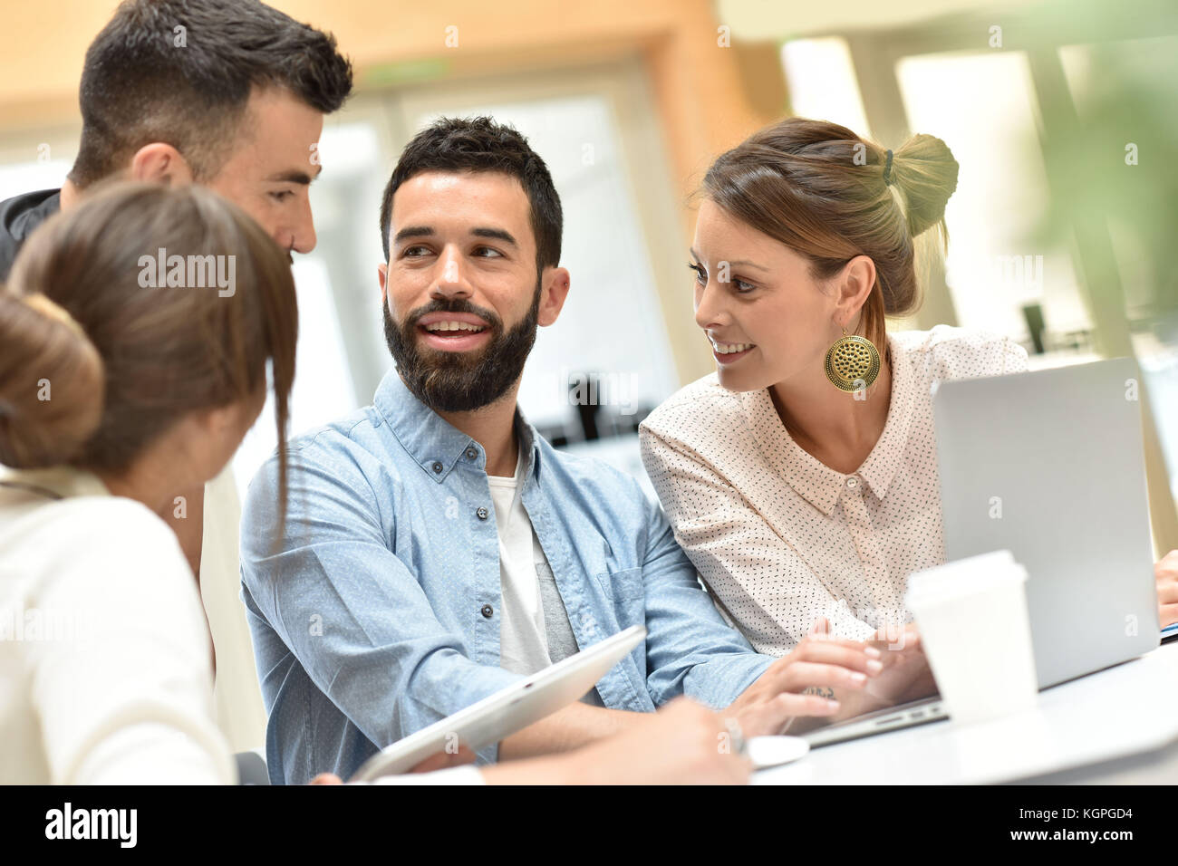 Design team meeting and working on laptop Stock Photo - Alamy