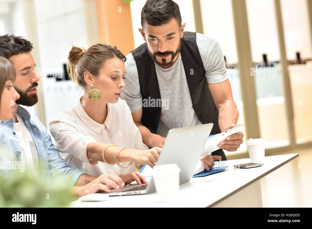 Design team meeting and working on laptop Stock Photo - Alamy