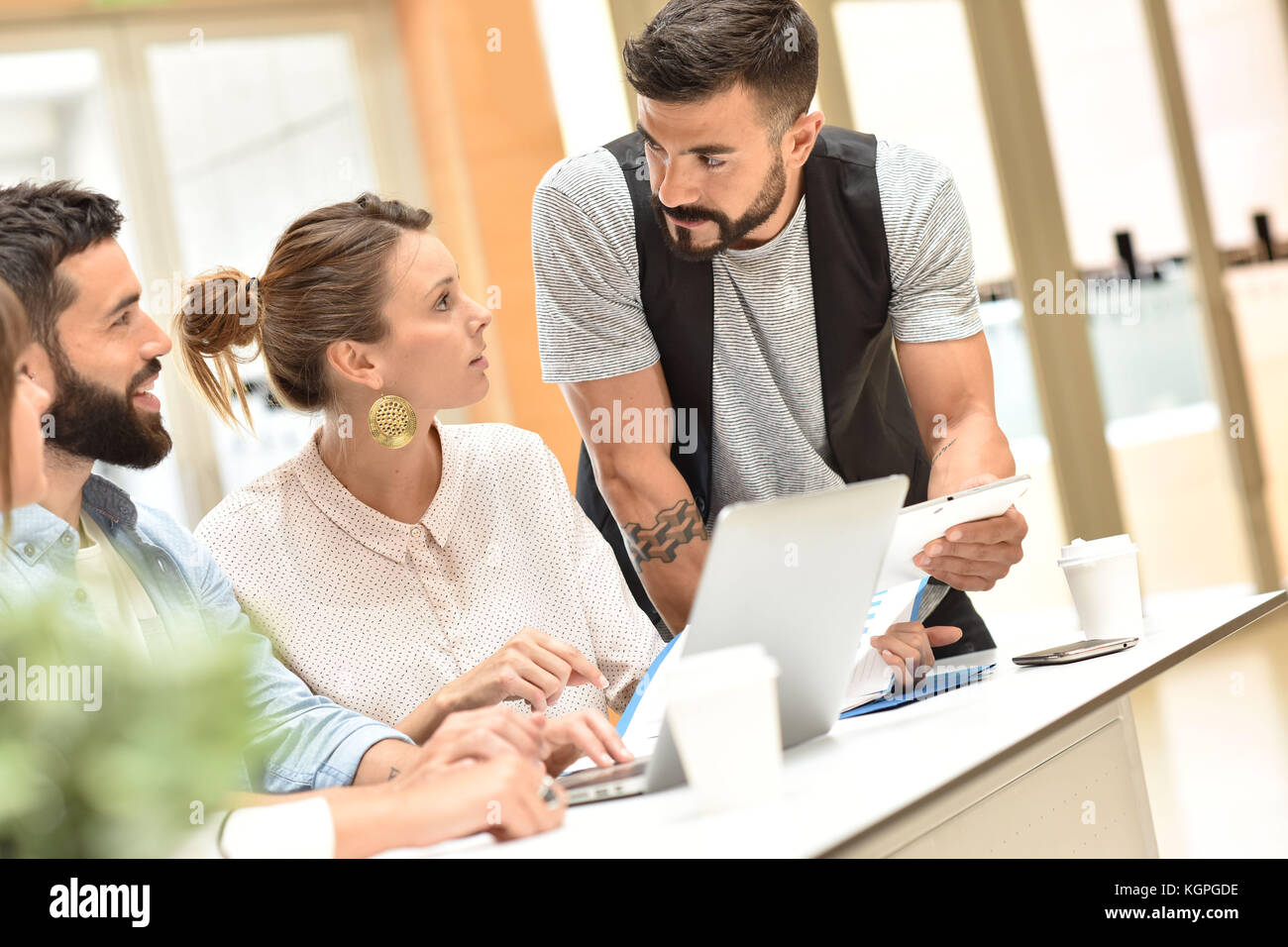 Design team meeting and working on laptop Stock Photo - Alamy