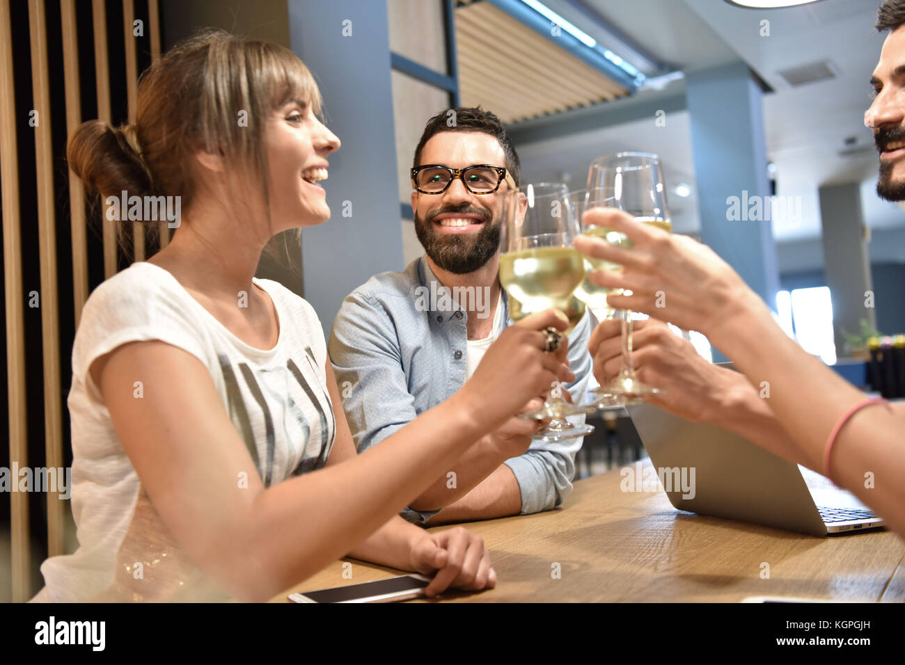 Group of young people cheering with wine glasses Stock Photo - Alamy