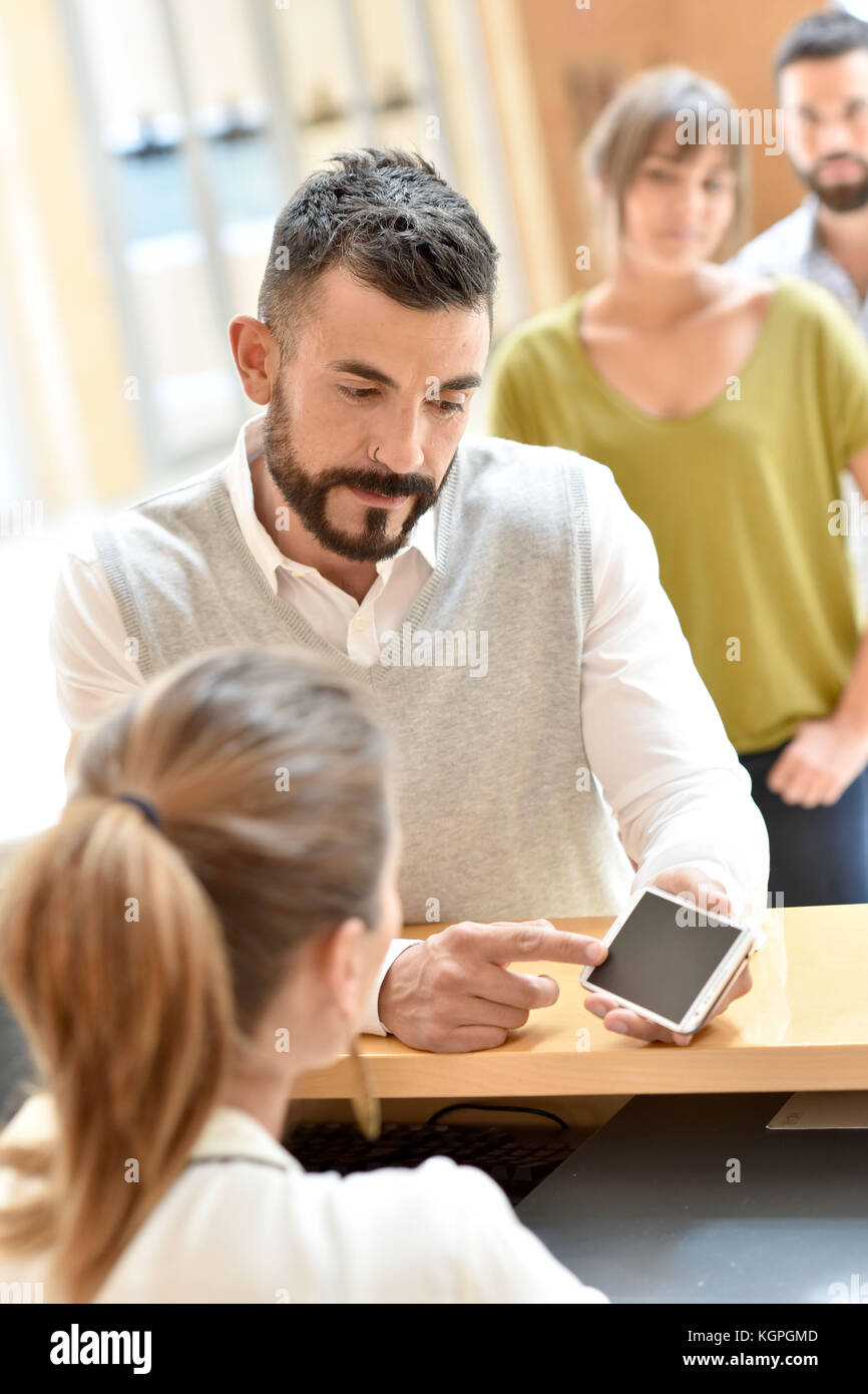 Man getting entrance ticket from e-reservation Stock Photo - Alamy