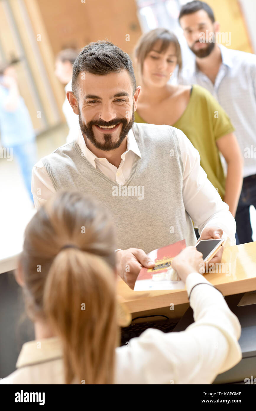 Man getting entrance ticket from e-reservation Stock Photo - Alamy
