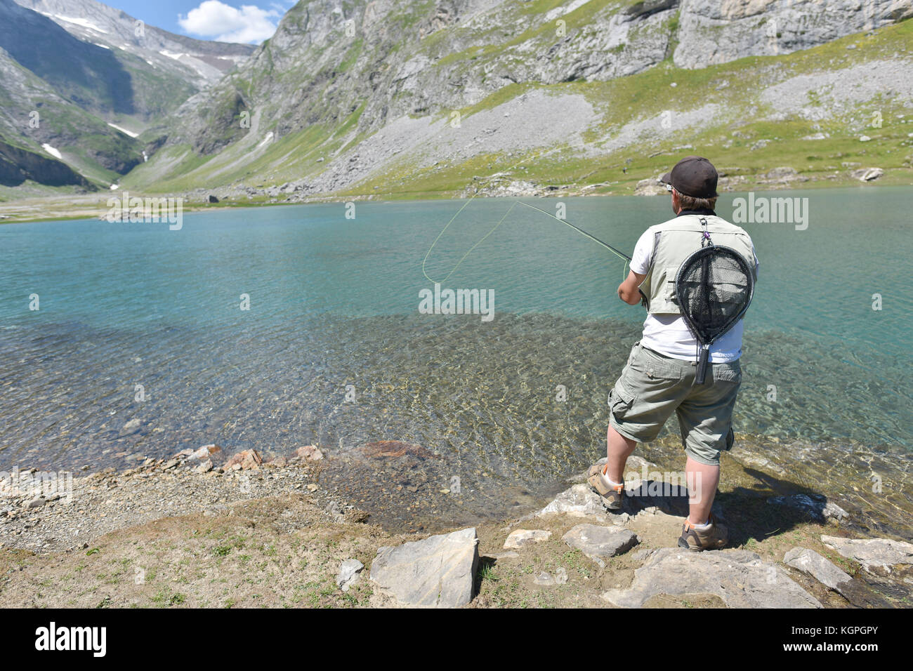 Flyfisherman fishing in mountain lake Stock Photo - Alamy
