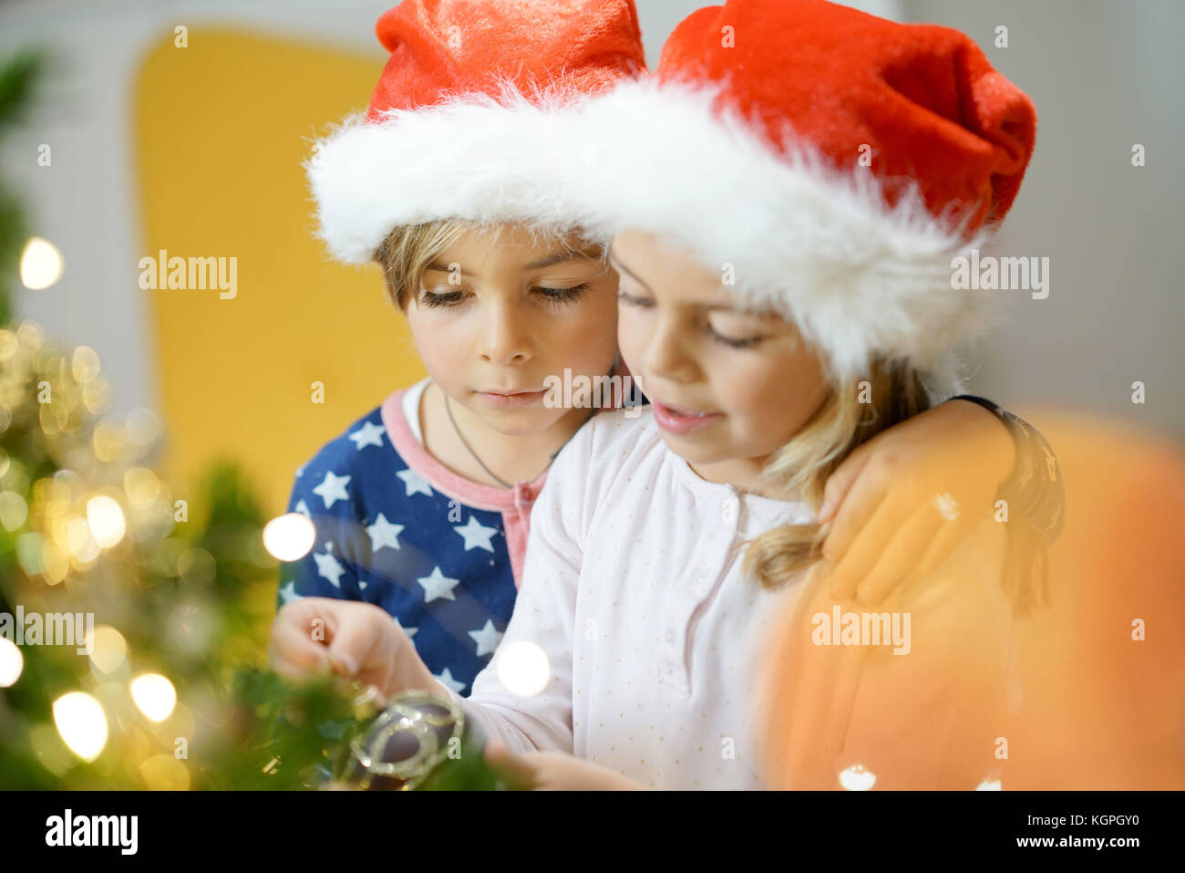 Kids decoration Christmas tree together Stock Photo - Alamy